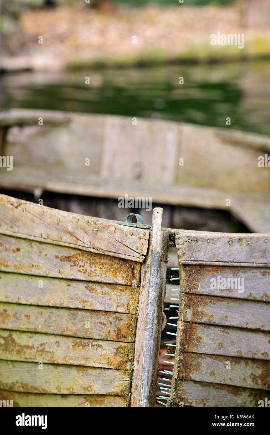 a rotten old wooden boat left out in the weather to rot Stock Photo - Alamy