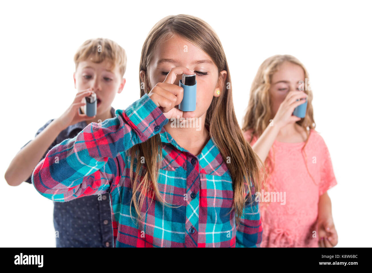 three childs using inhaler for asthma. White background Stock Photo - Alamy