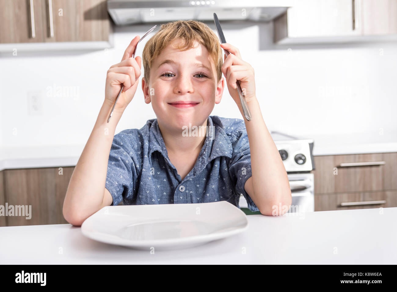 Boy holding out a plate Stock Photo - Alamy
