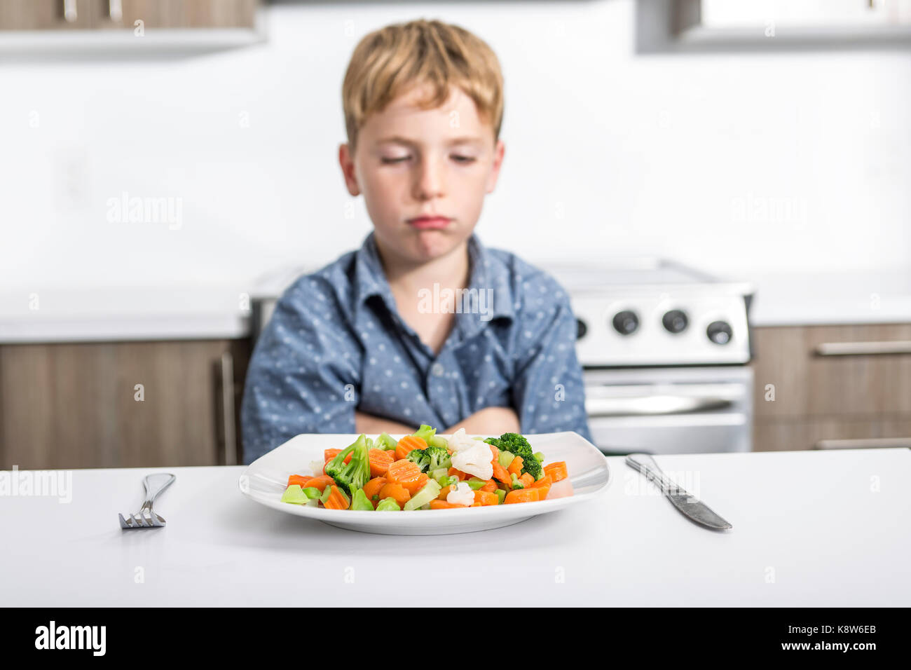 boring expression with fresh colorful vegetables child Stock Photo - Alamy