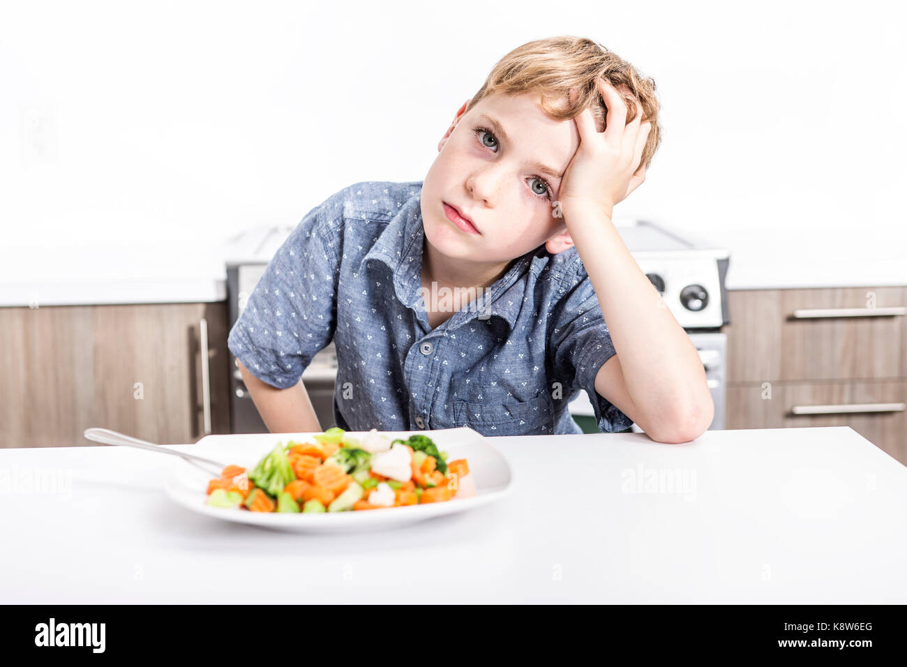 boring expression with fresh colorful vegetables child Stock Photo - Alamy