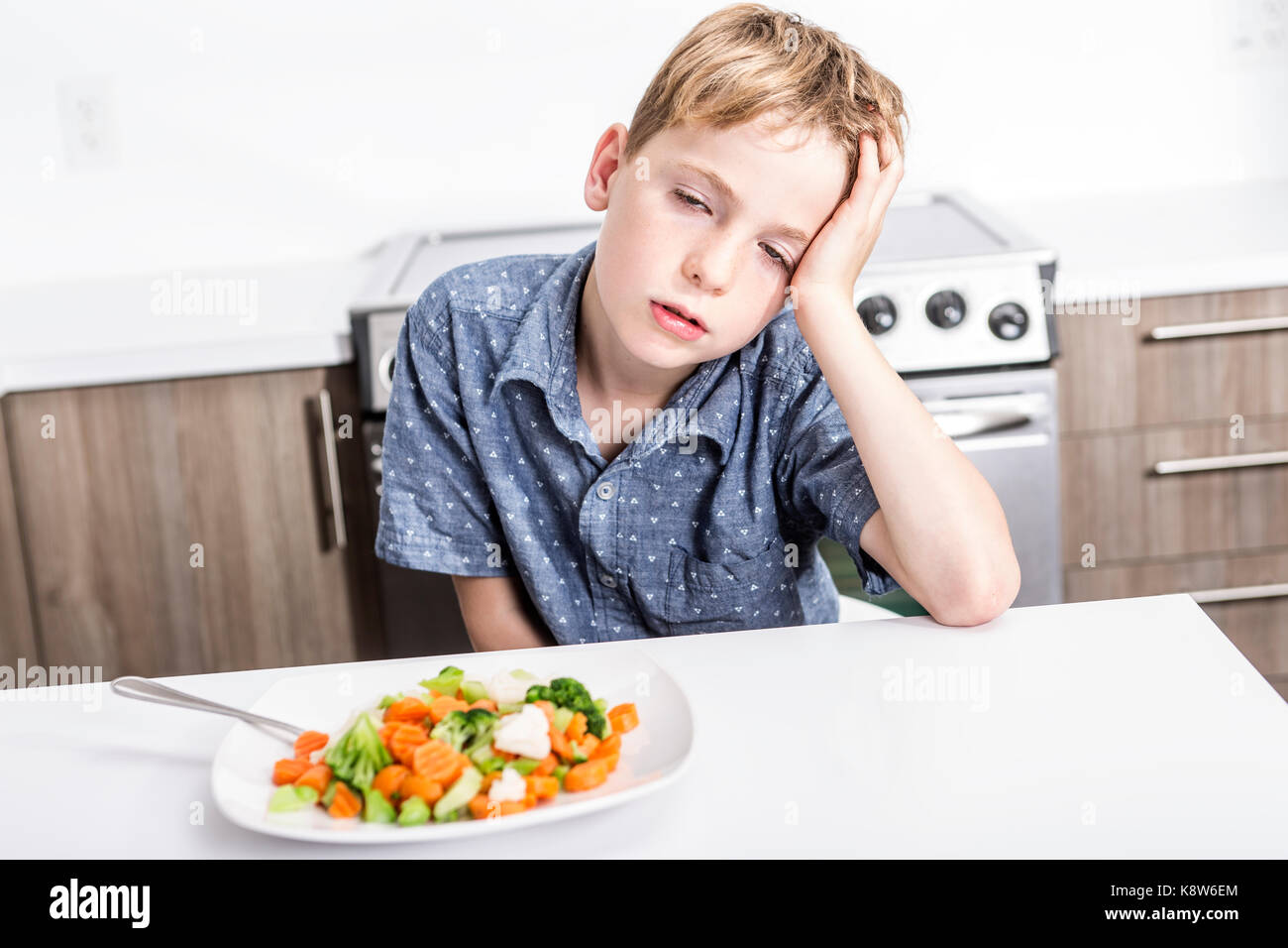 boring expression with fresh colorful vegetables child Stock Photo - Alamy