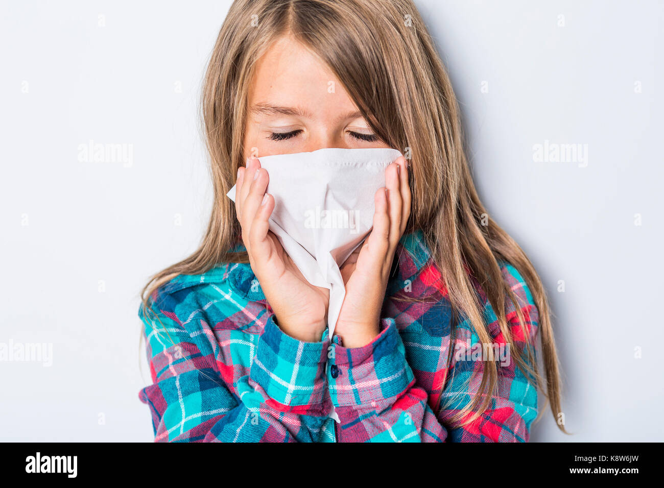 girl sneeze with napkin paper on white background Stock Photo - Alamy