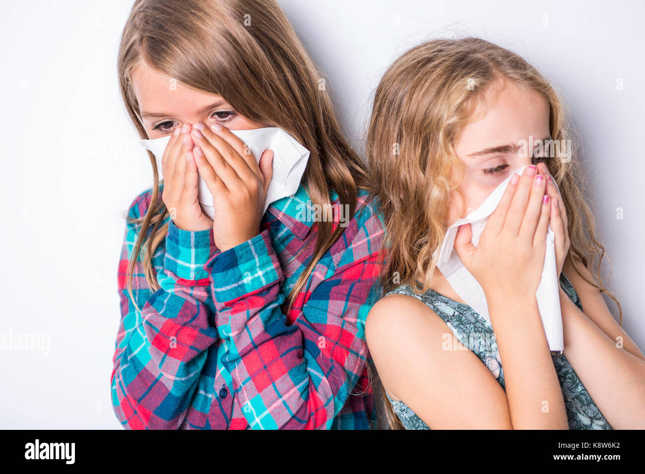 girl sneeze with napkin paper on white background Stock Photo - Alamy