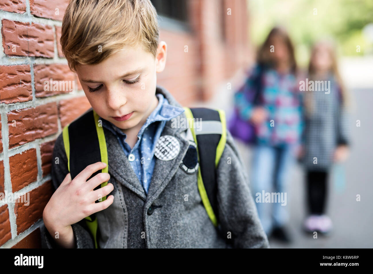 Pupils friends teasing a pupil alone primary school Stock Photo - Alamy