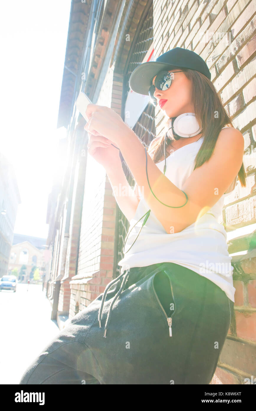A beautiful young Hip Hop Rapper girl with Headphones in a urban ...