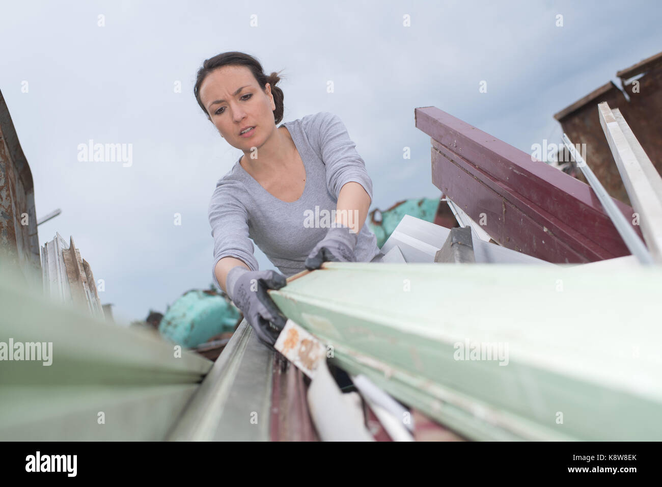 putting rubbish in the skip Stock Photo - Alamy