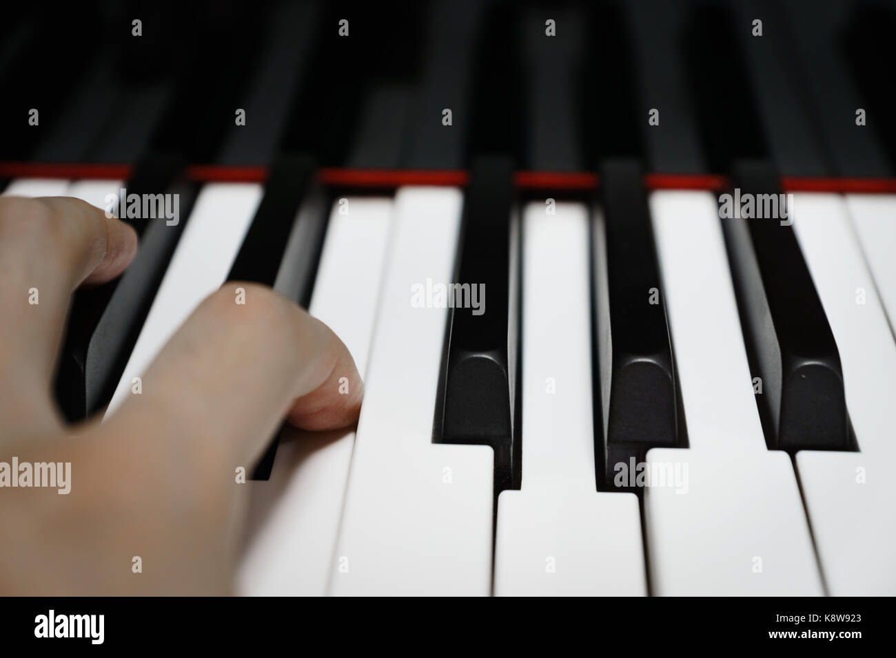 Piano keys on black classical grand piano play Stock Photo - Alamy