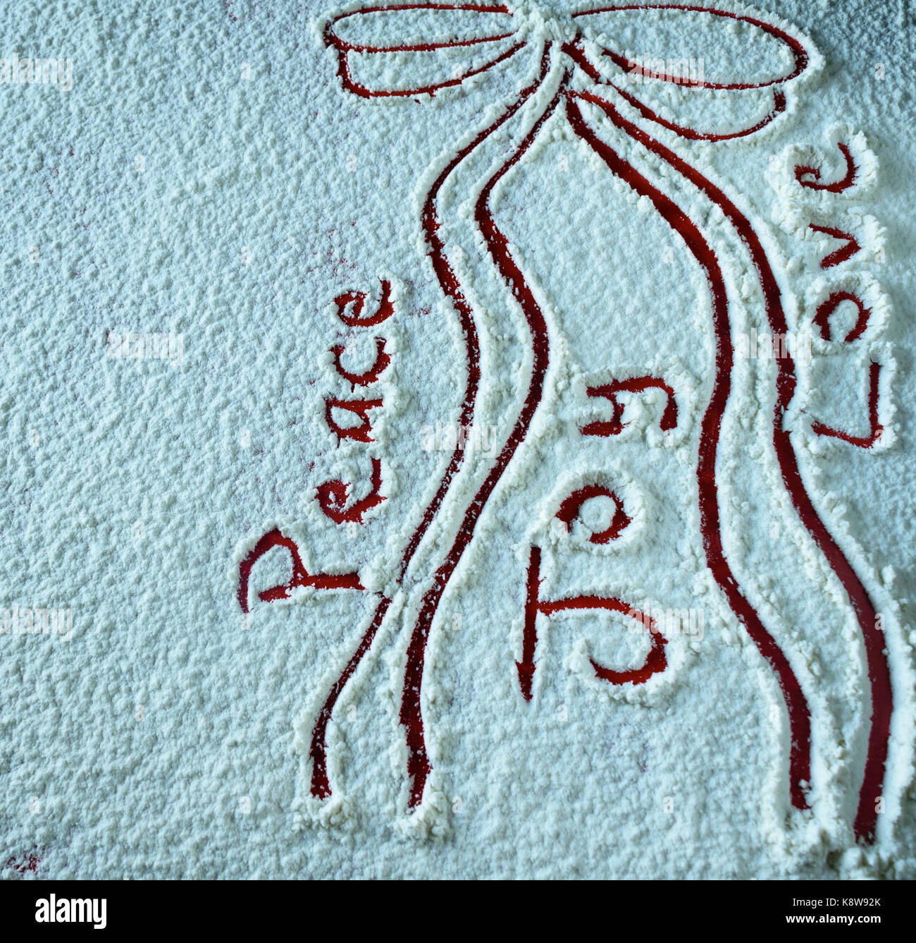 Red Christmas Bow Drawing in Flour that resembles snow or ice Stock ...