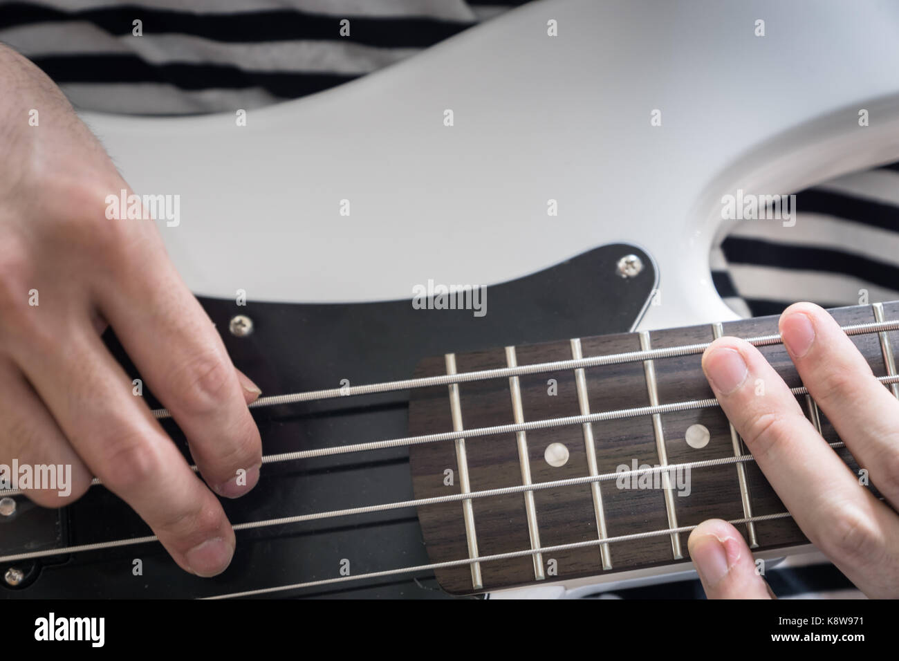 bass guitar finger style closeup - musical instruments - concept ...