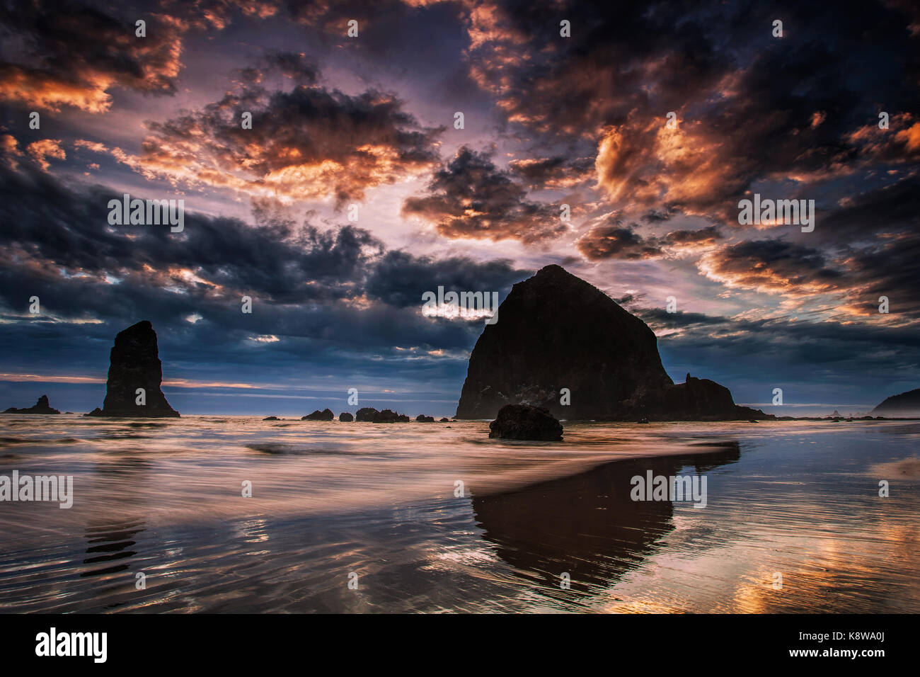 Oregon's Cannon Beach at sunset. Standing guard over the scene is the ...