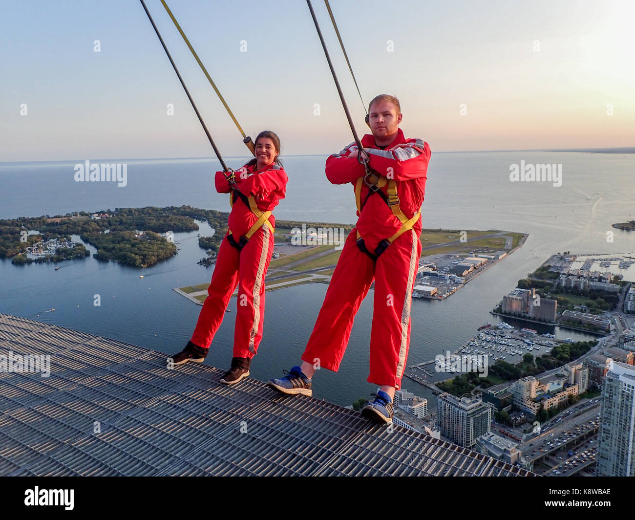 Real people doing the EdgeWalk at the CN Tower in the late afternoon ...