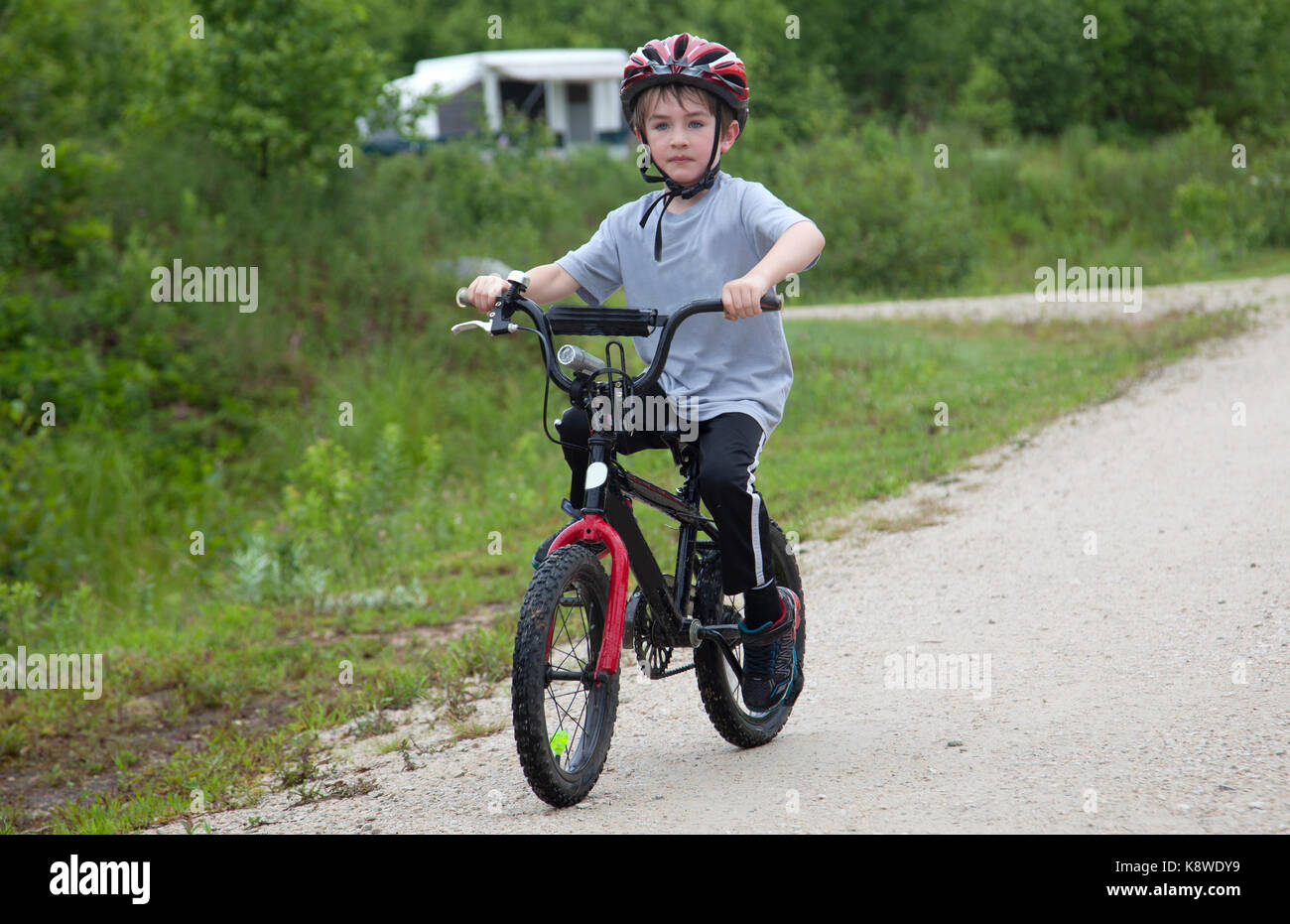 young child rides a bicycle alone on a dirt road Stock Photo - Alamy