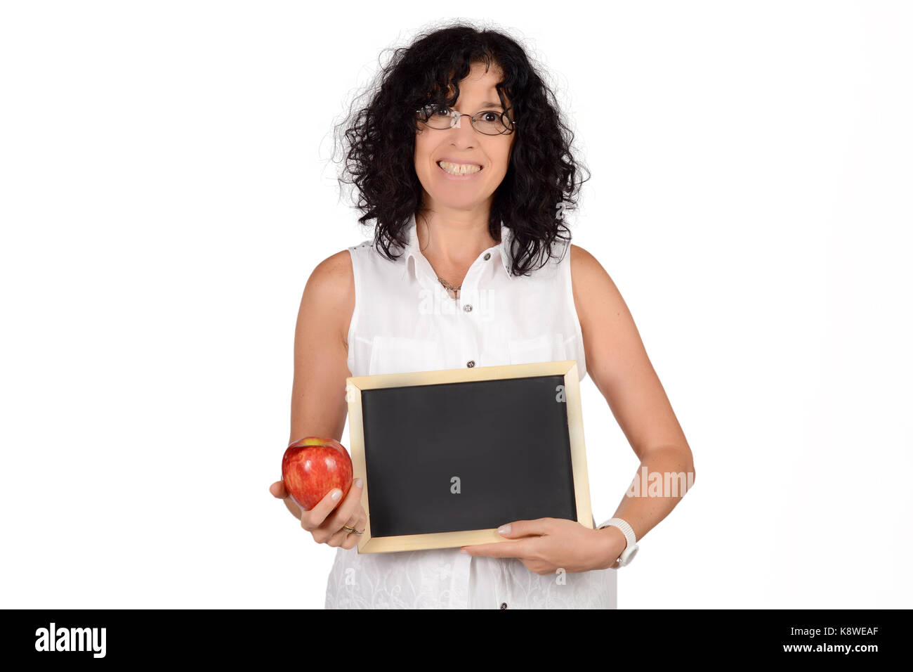 Portrait of beautiful school teacher holding an empty chalkboard ...