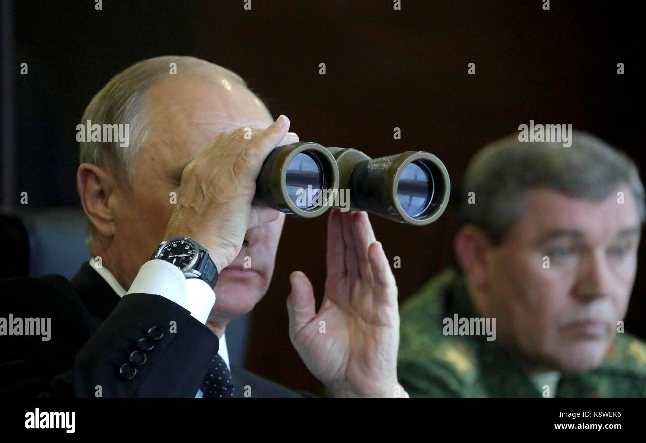 Russian President Vladimir Putin looks through binoculars as Russian ...