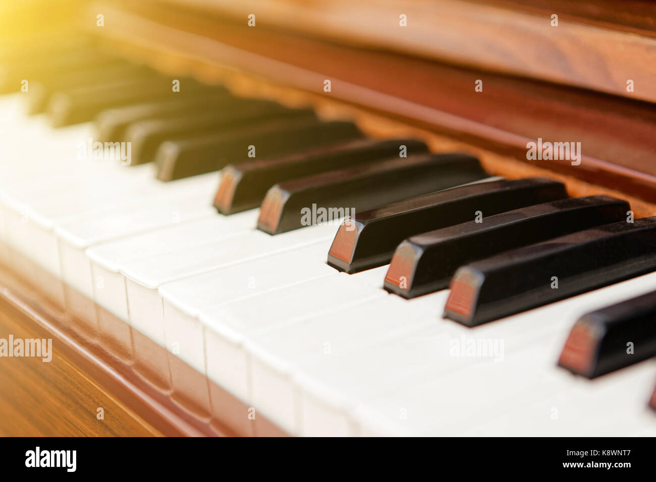 Brown color classical piano with black and white keys Stock Photo - Alamy