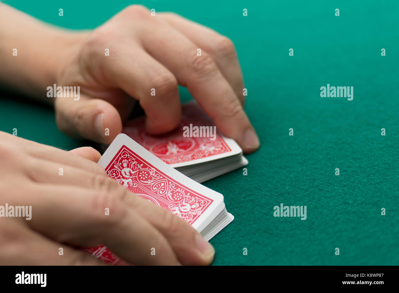 Poker player shuffling cards, close-up Stock Photo - Alamy