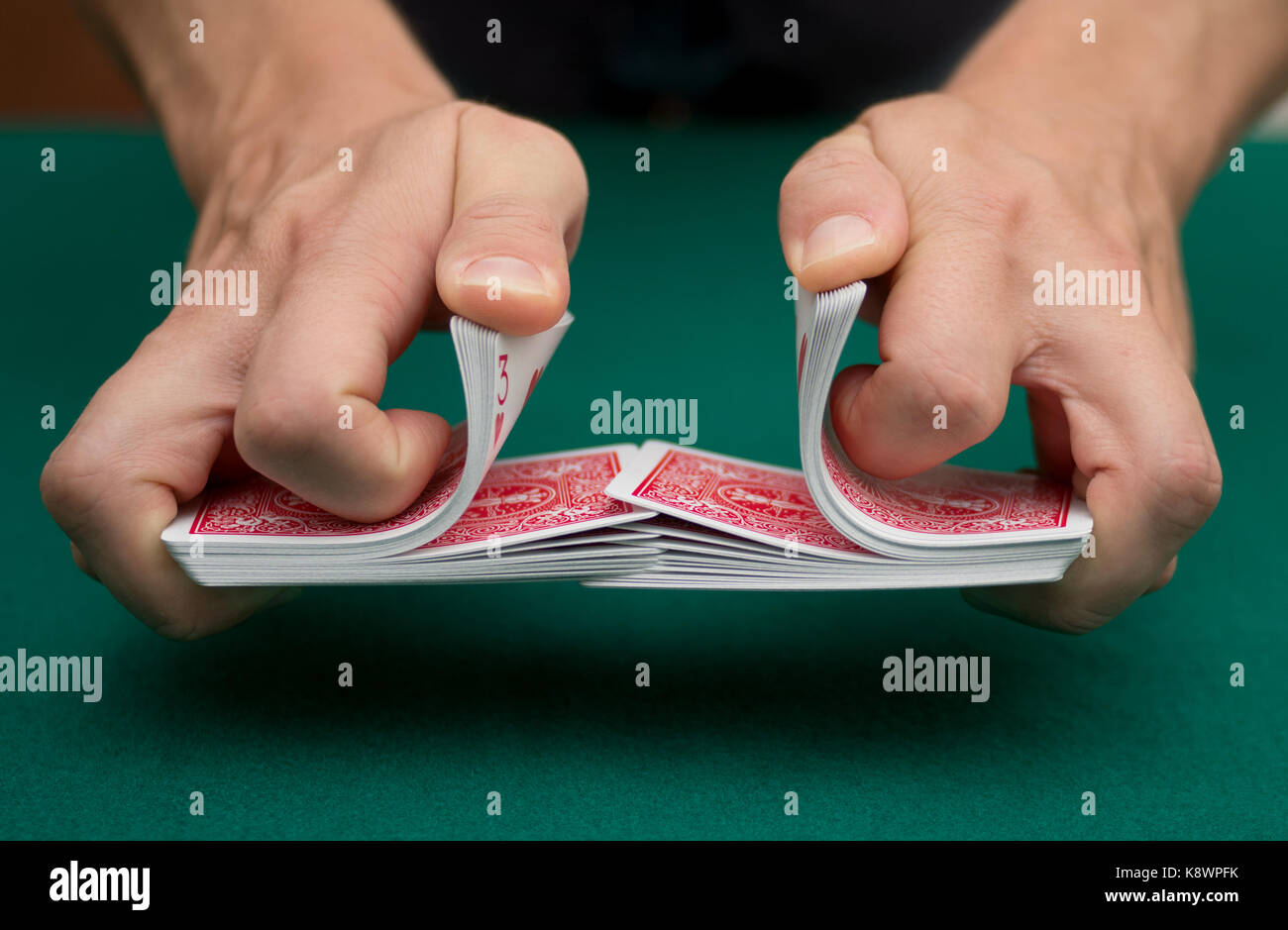 Poker player shuffling cards, close-up Stock Photo - Alamy