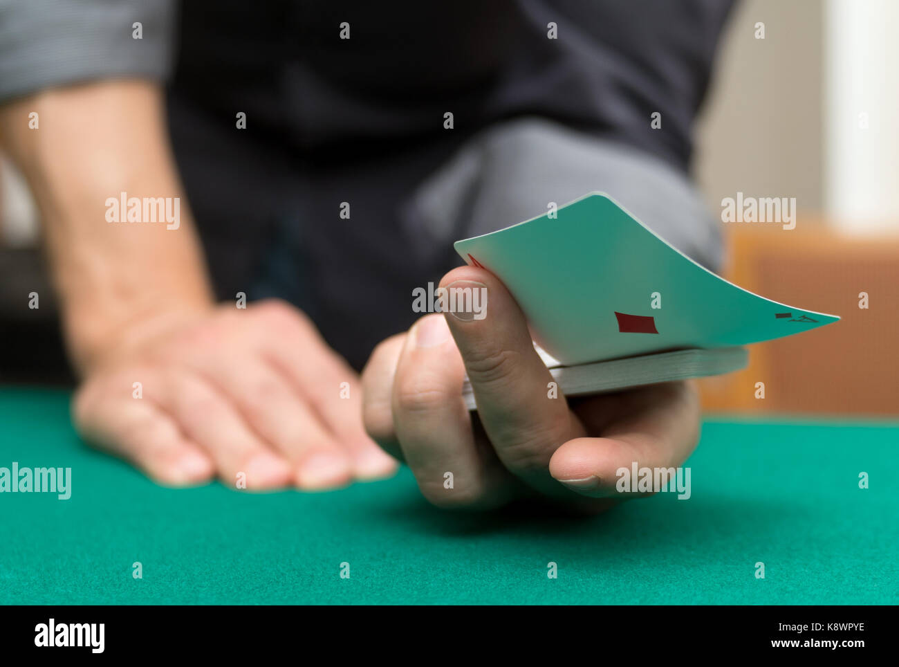 Poker player holding playing cards Stock Photo - Alamy