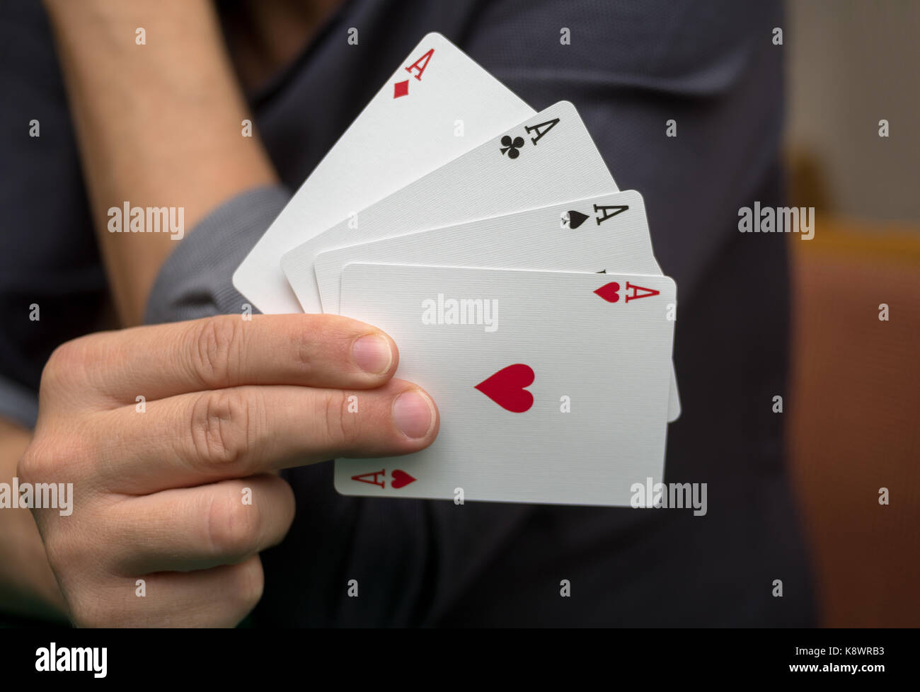 Poker player holding playing cards Stock Photo - Alamy