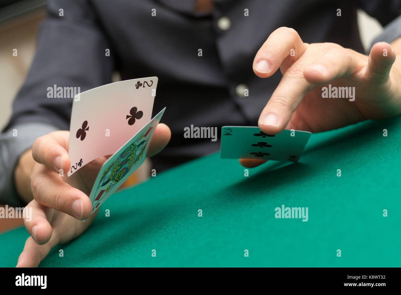 Poker player holding playing cards Stock Photo - Alamy