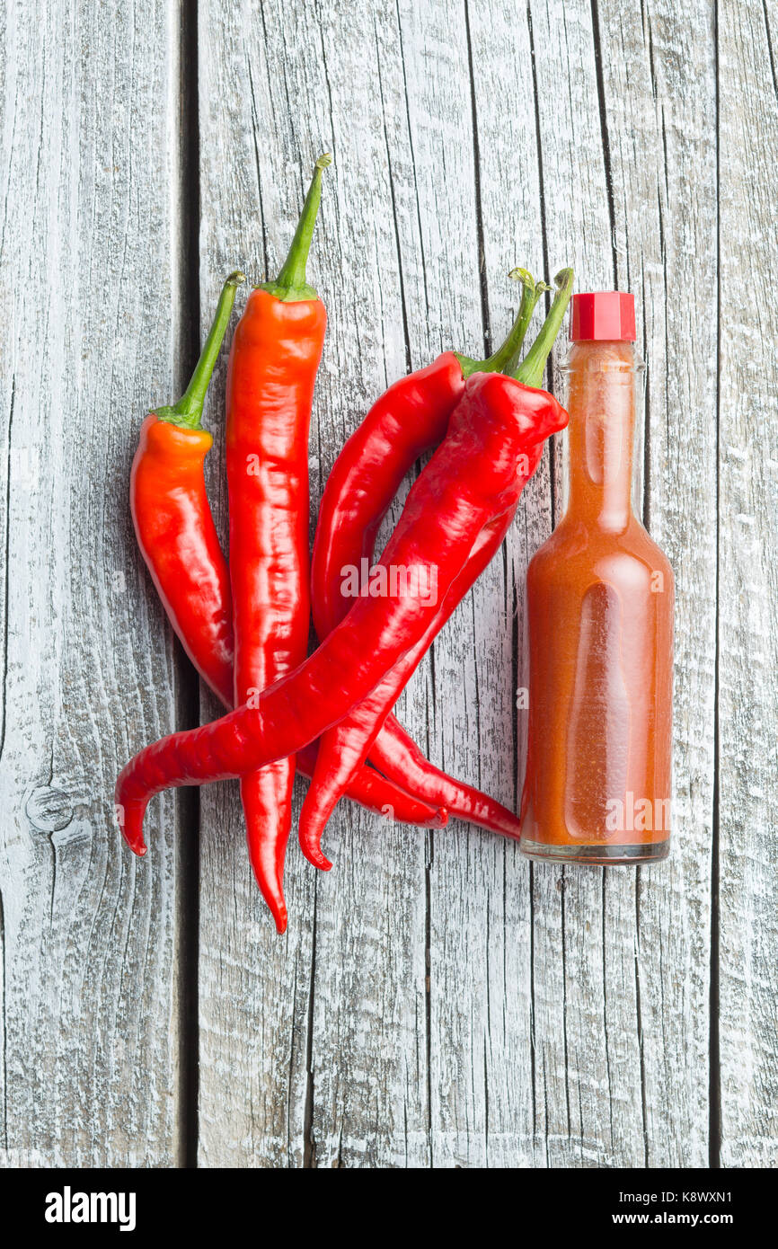 Red chili peppers and chili sauce. Top view Stock Photo - Alamy