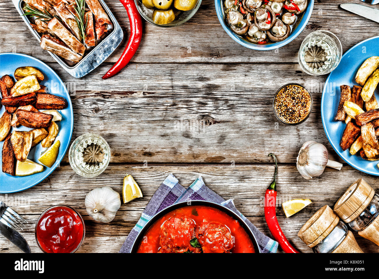 Dining table with a variety of meals and snacks. Meatballs, baked ...