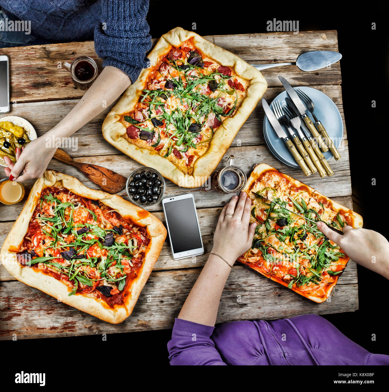 Cutting pizza. Domestic food and homemade pizza. Enjoying dinner with ...