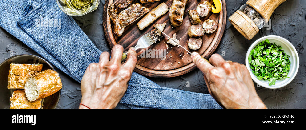 Man eats a juicy barbecue steak. movie effect Stock Photo - Alamy