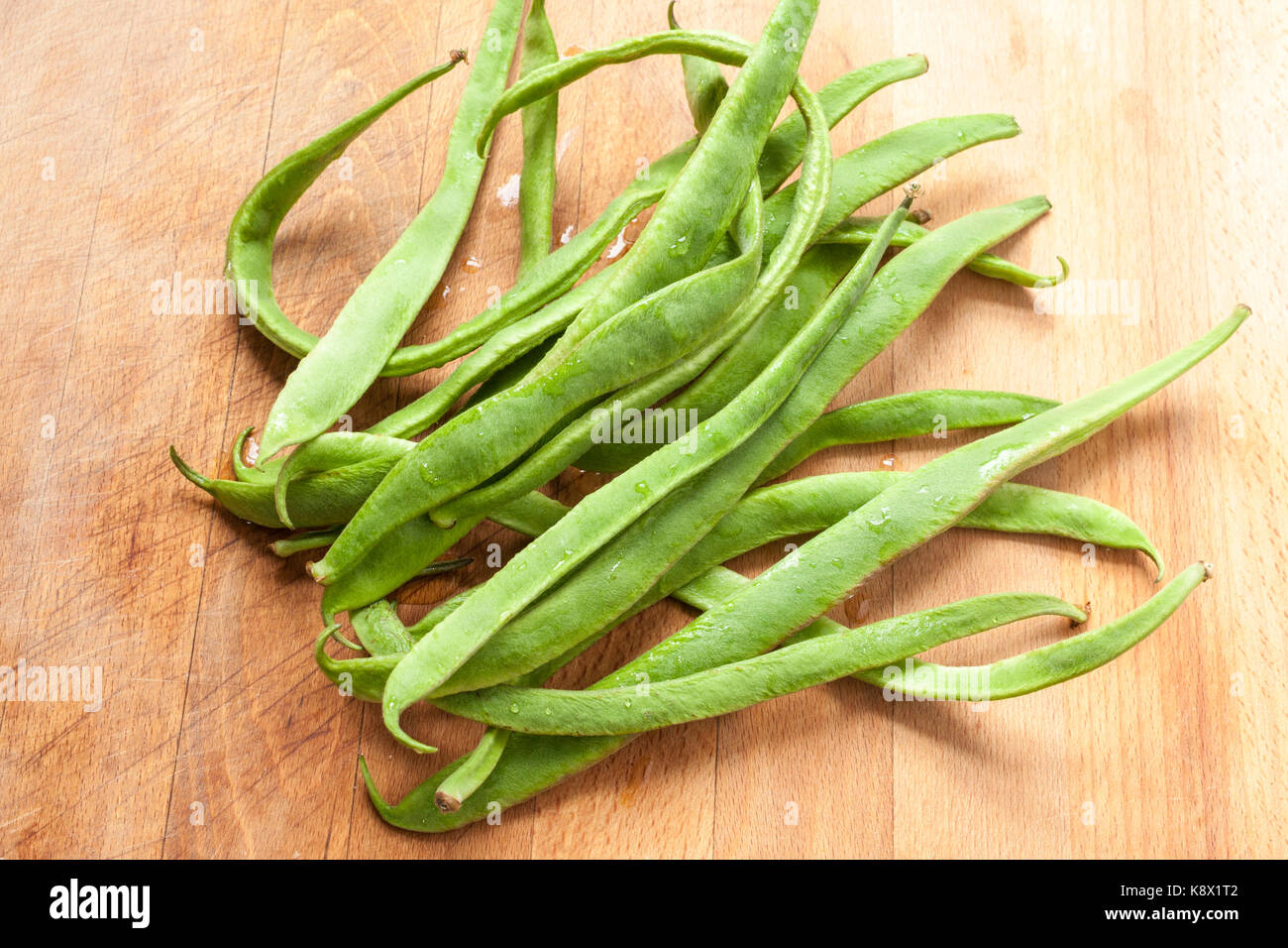 Fresh homegrown runner beans laying a wooden surface Stock Photo - Alamy