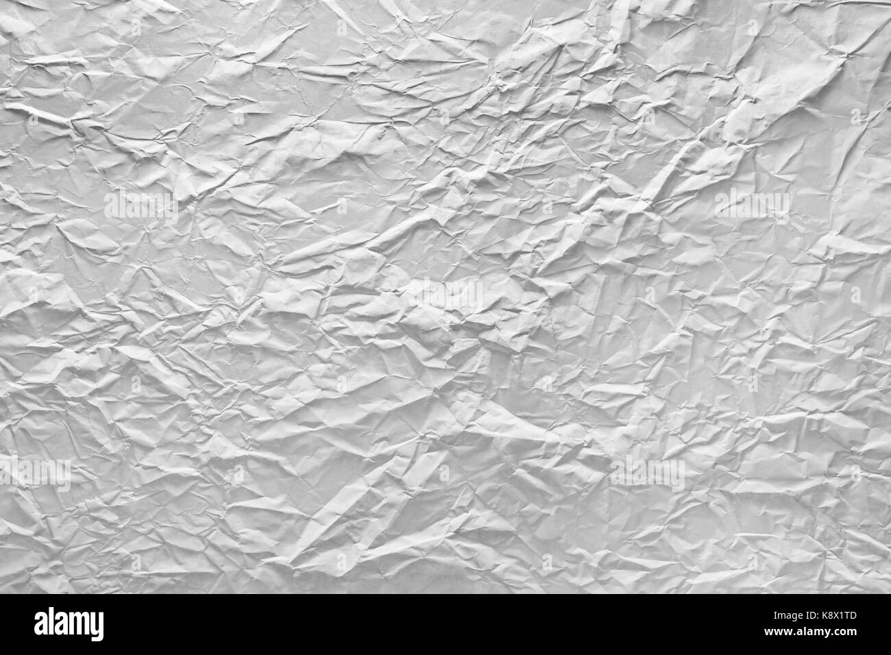 Surface of crumpled paper highlighted by light. Stressed, illuminated ...