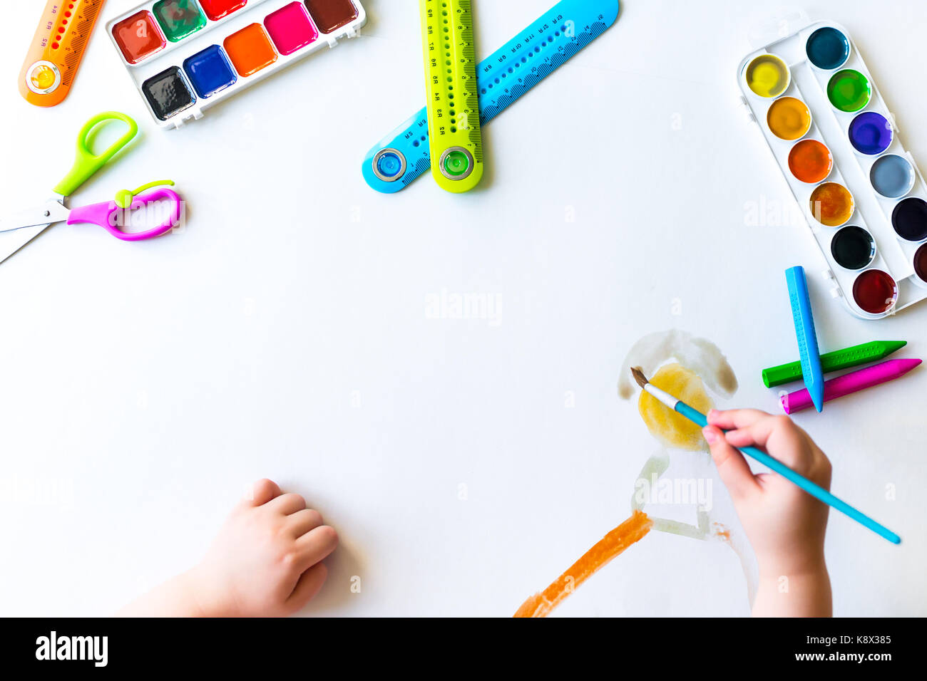 Kid is drawing with watercolors Stock Photo - Alamy