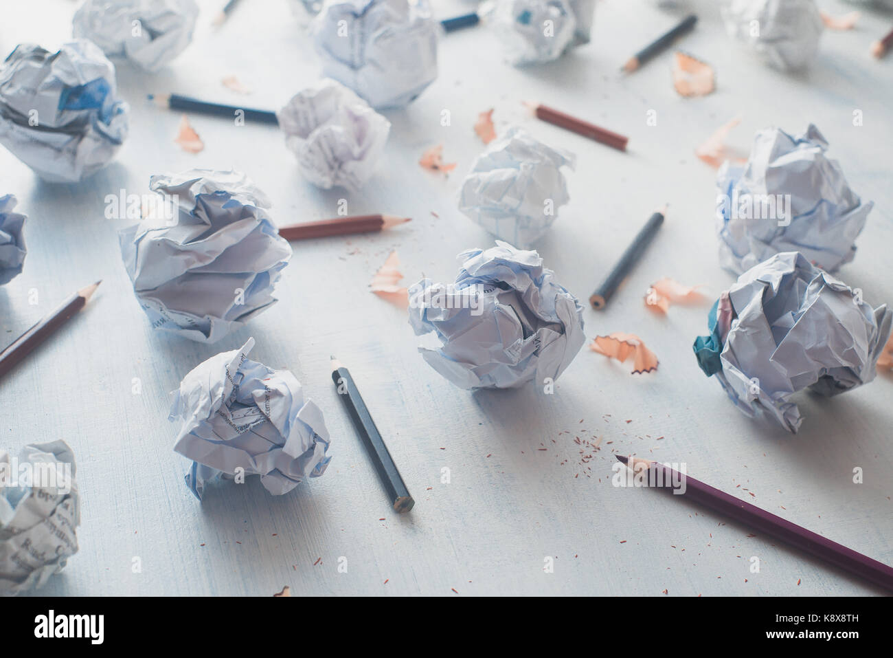 Close-up of crumpled paper balls on a white wooden background with ...