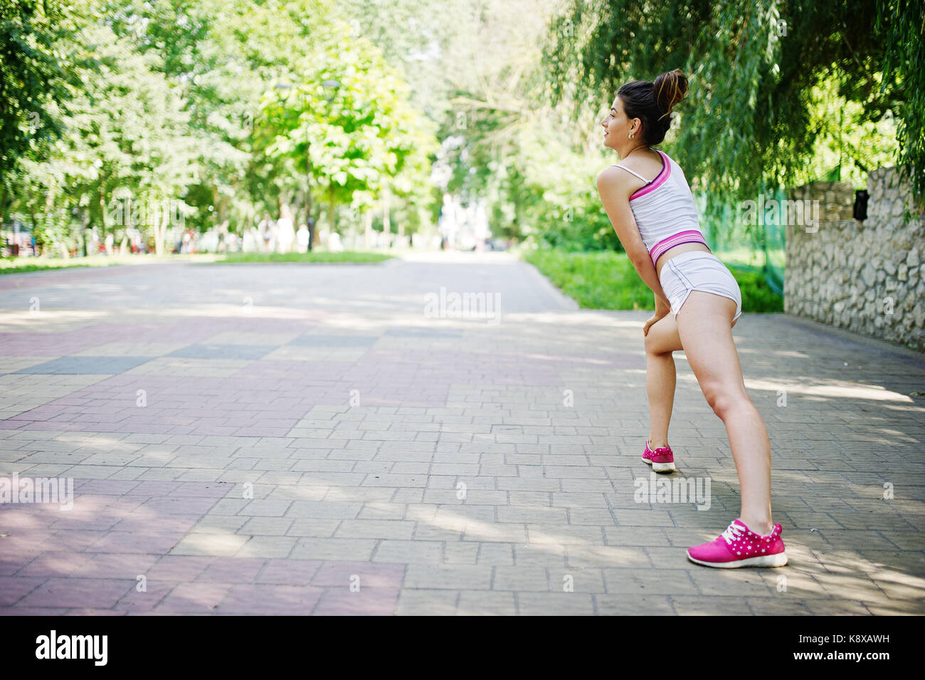 Sport girl wear on white shorts ans shirt doing exercise at park Stock ...