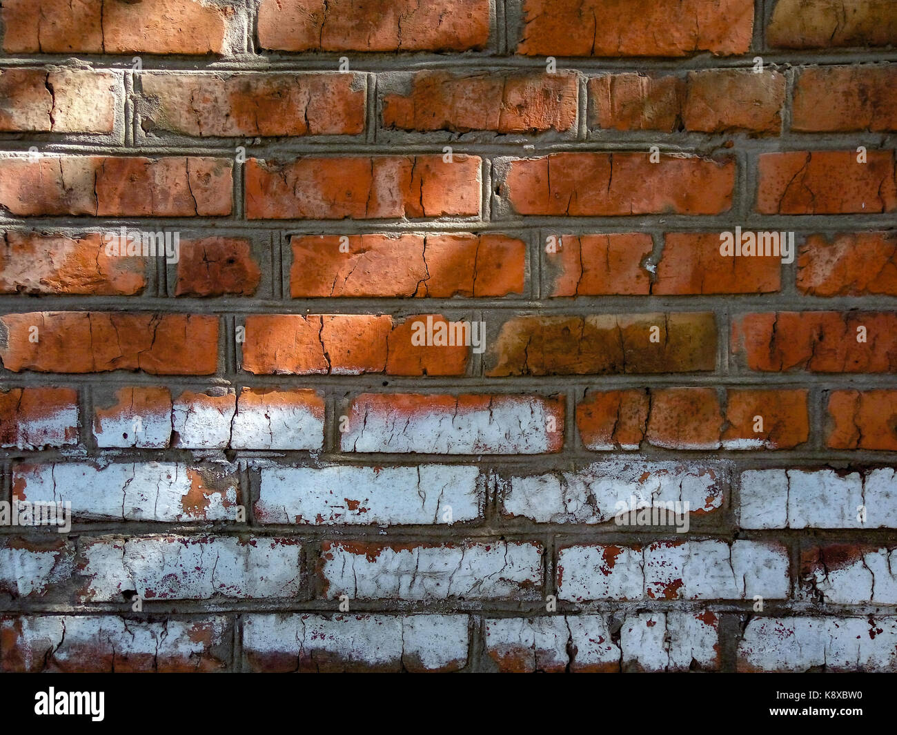A close-up shot of a rough brick masonry wall lined with red clumsy ...