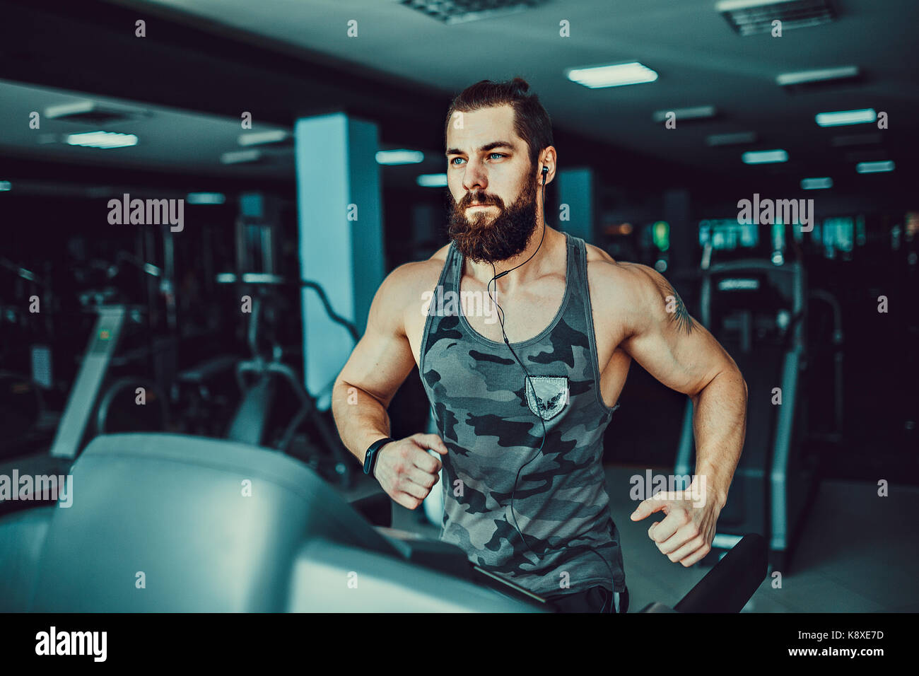 Muscle man running on treadmill Stock Photo - Alamy