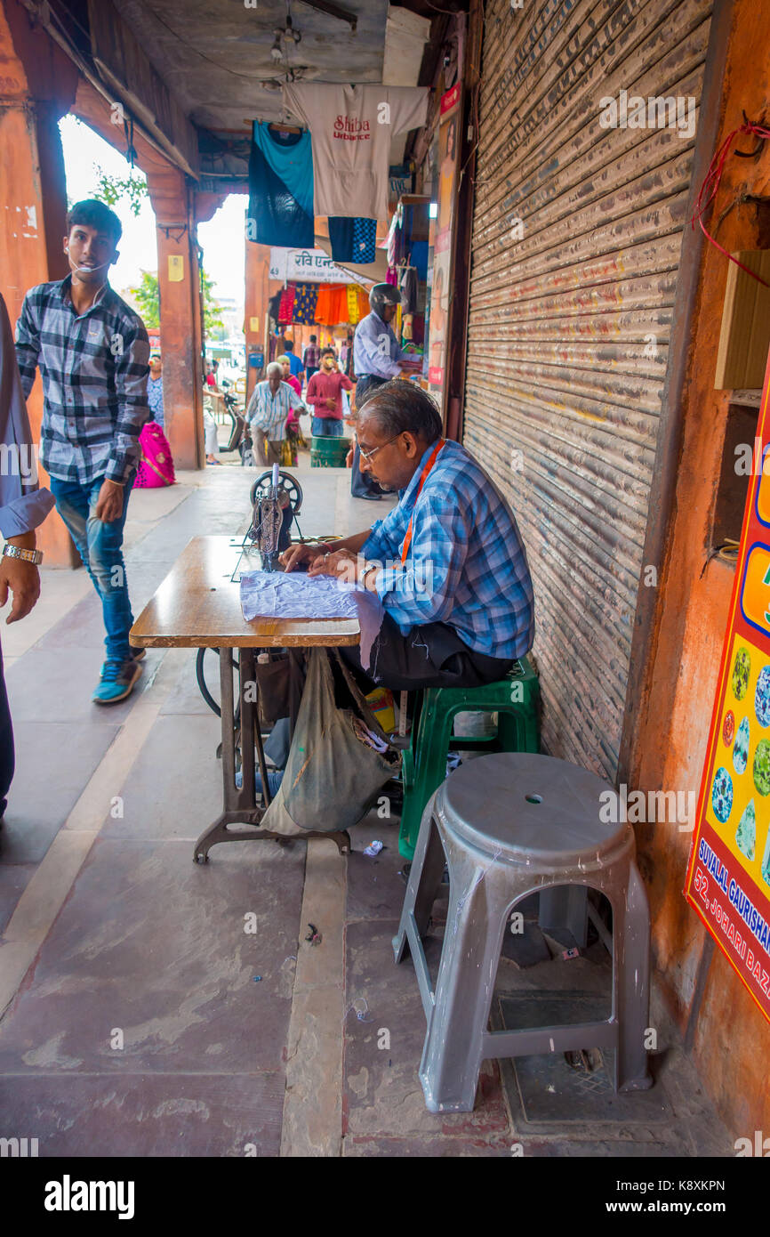 Jaipur, India - September 20, 2017: A man stitching clothes with his ...