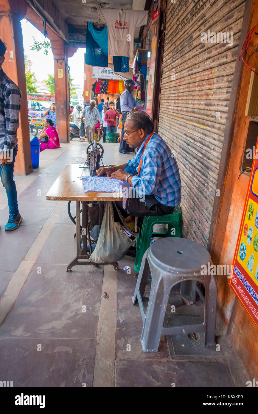 Jaipur, India - September 20, 2017: A man stitching clothes with his ...