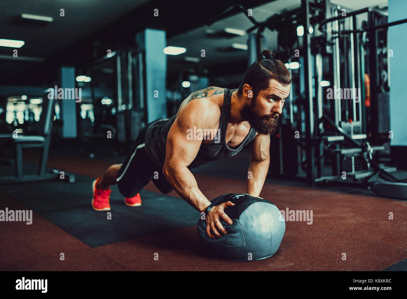 Plank it! Confident muscled young man wearing sport wear and doing ...