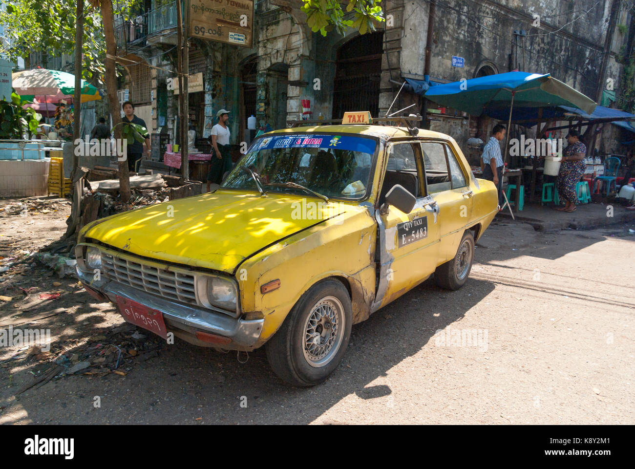 Yellow Taxi parked on the street in Yangon, Myanmar,Asia Stock Photo ...