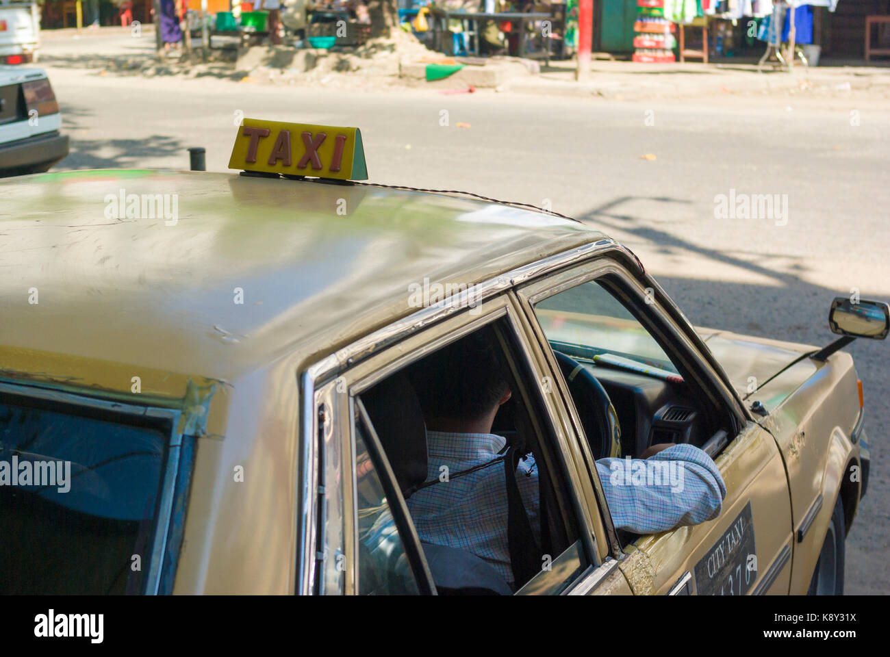 Yellow Taxi in Yangon, Myanmar Stock Photo - Alamy
