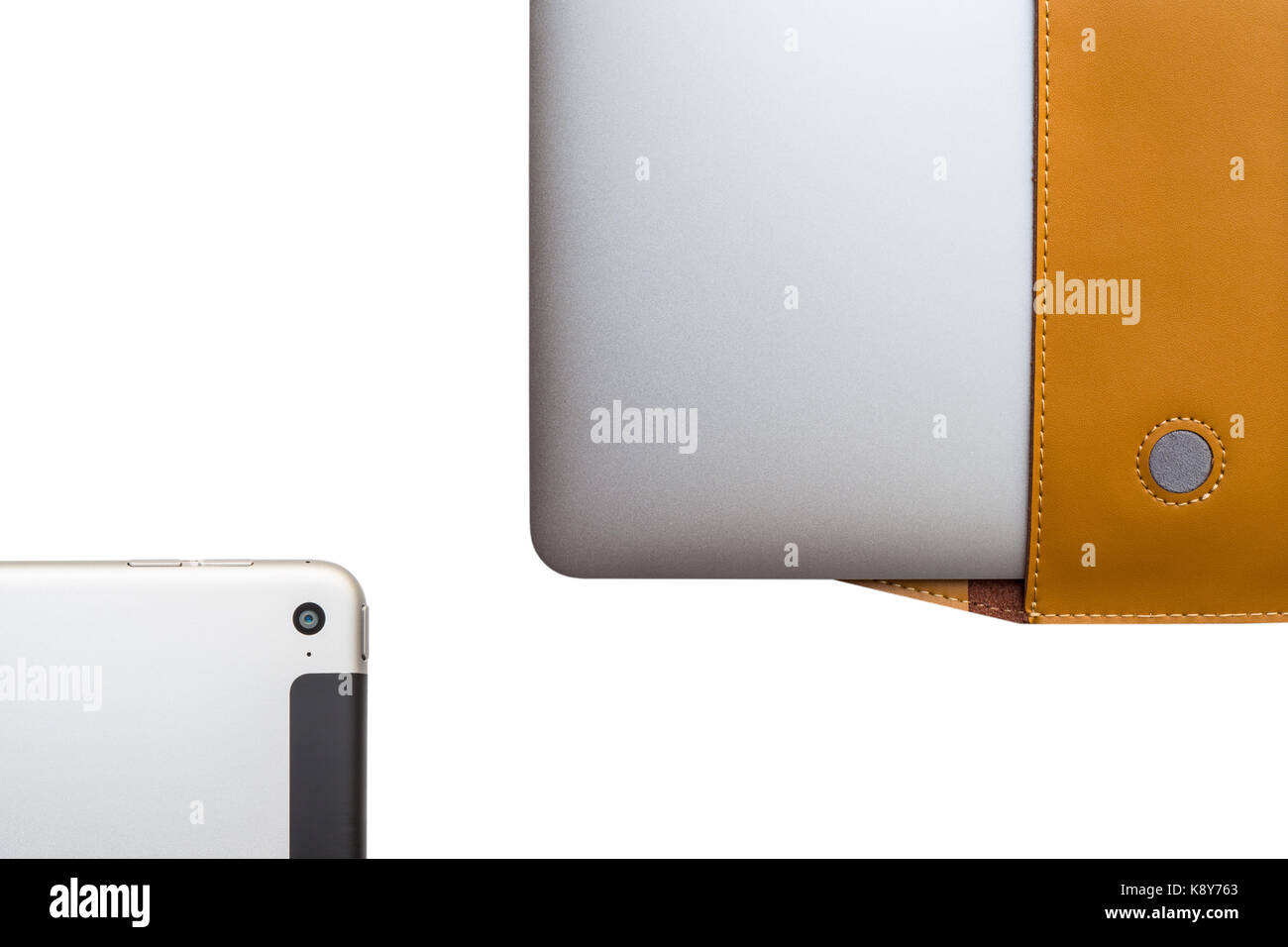 Tablet and Portable computer in a leather cover case on white ...
