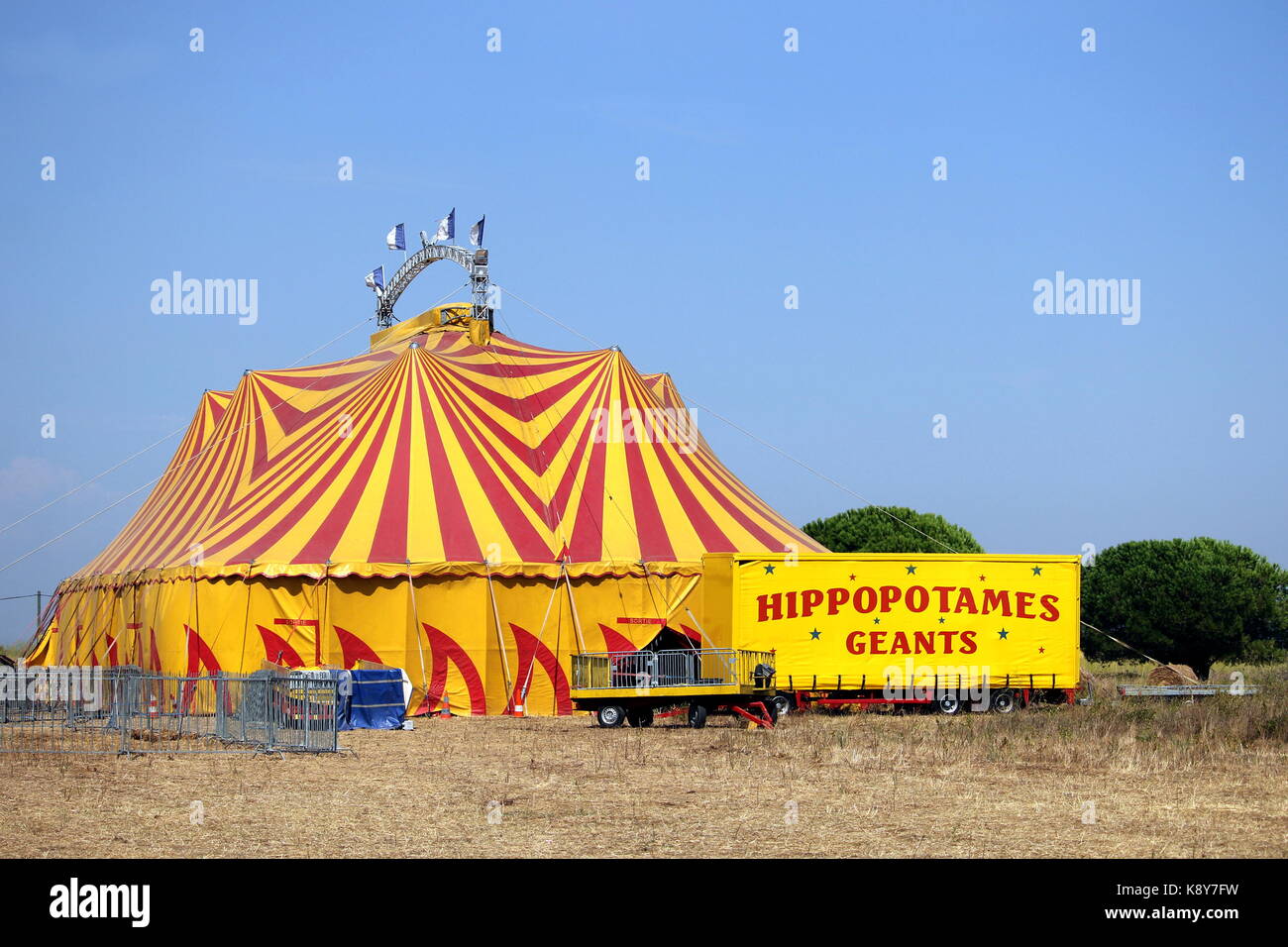 Colourful red and yellow Circus Big Top in France, plus a trailer ...
