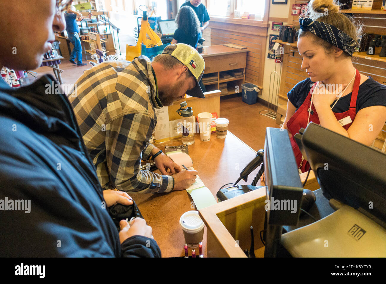 Men purchasing a fishing permit at the Tower General Store in ...
