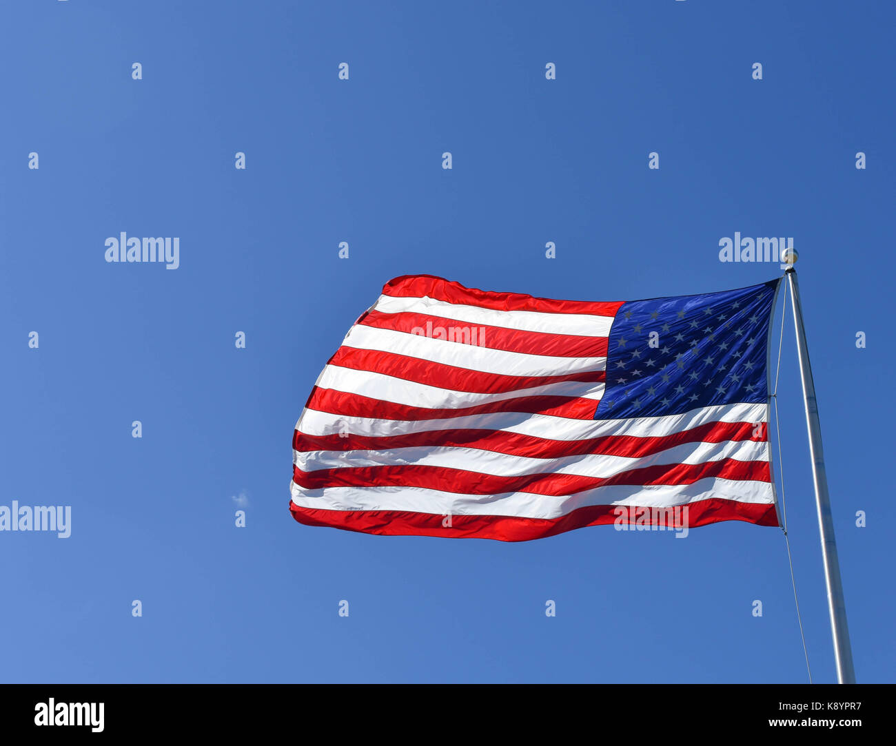 Side View of Large American Flag with beautiful sun highlights Stock ...
