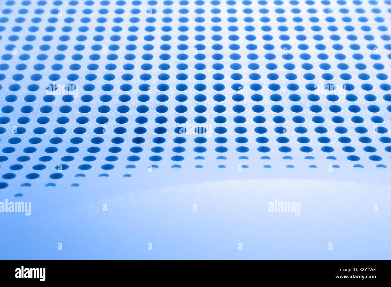 Abstract light colored surface with holes built in a row for creativity ...