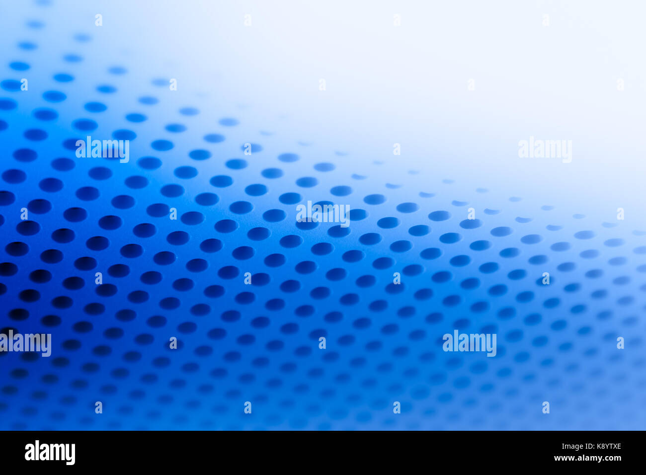 Abstract light colored surface with holes built in a row for creativity ...