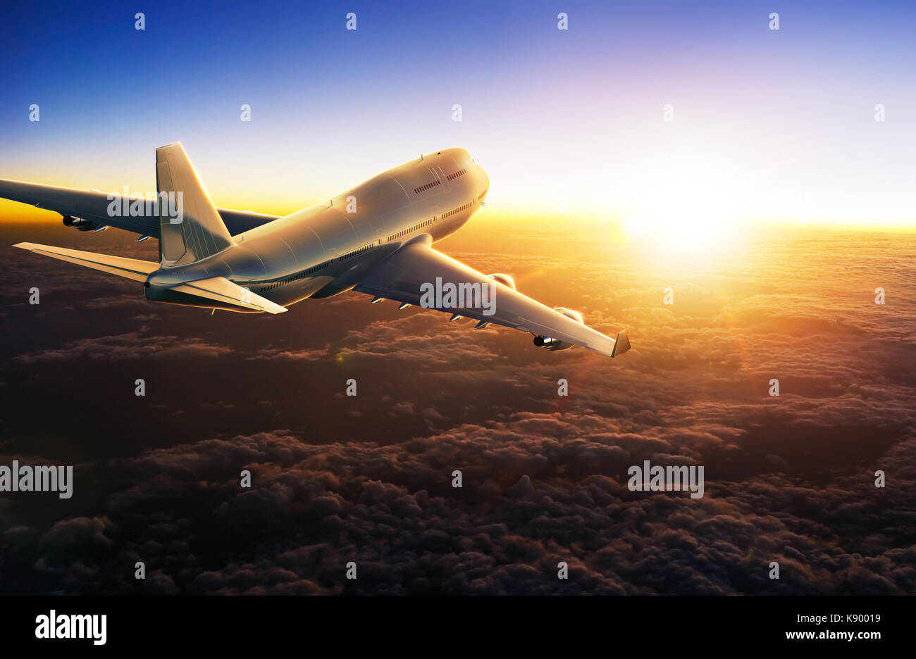 Airplane flying above clouds during sunset Stock Photo - Alamy