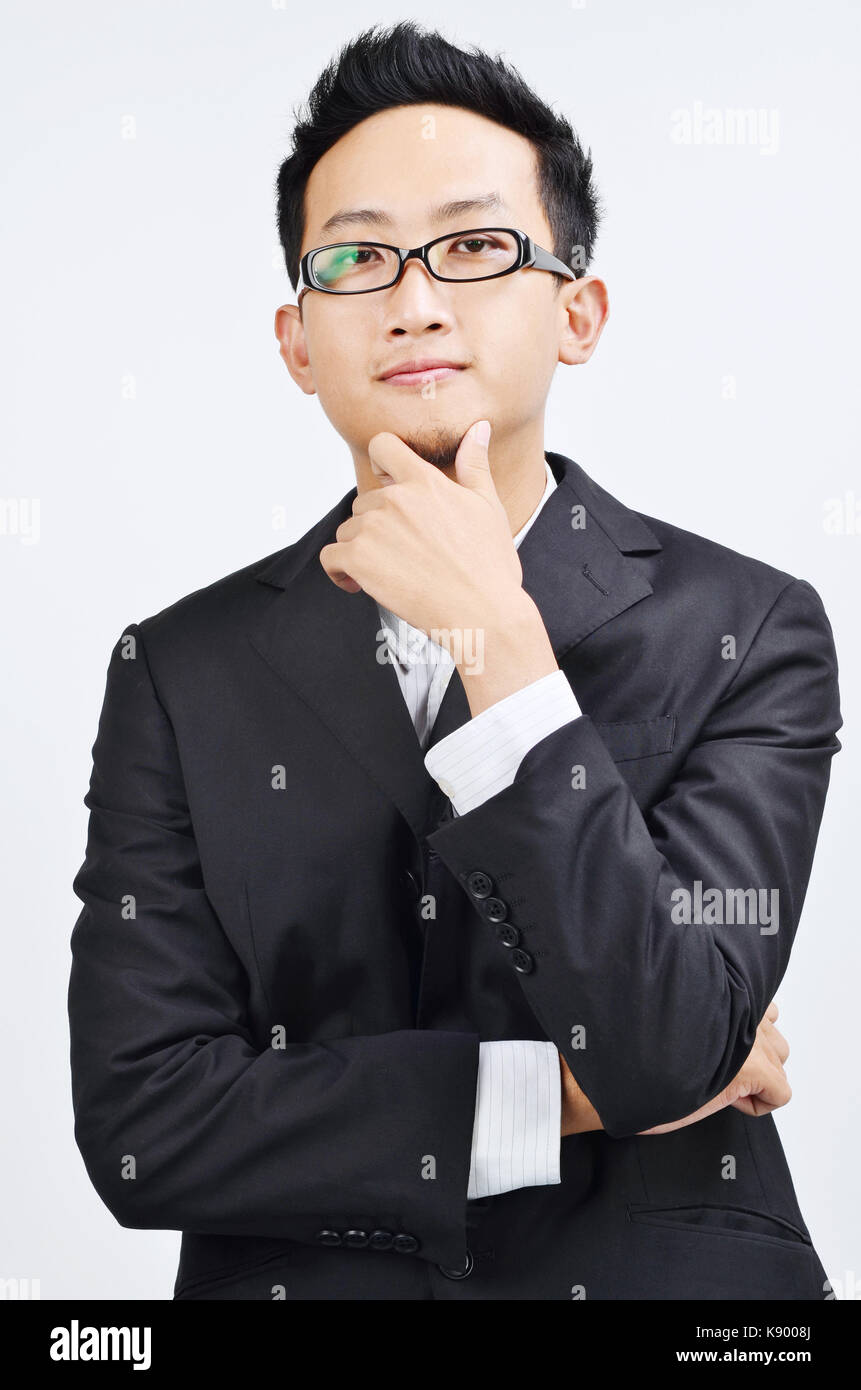 Portrait of smart Asian businessman arms crossed, thinking and looking ...