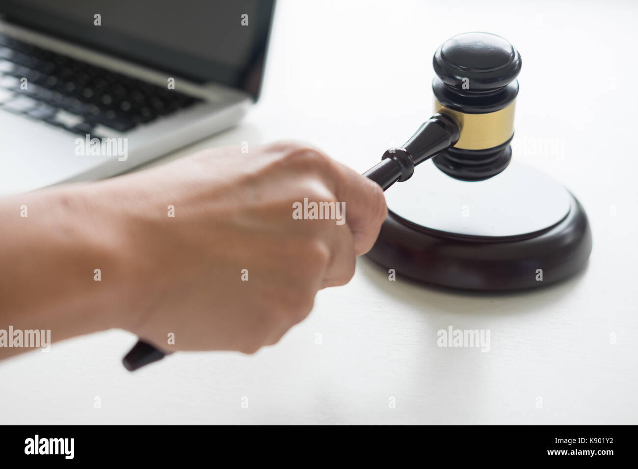 Male Judge lawyer In A Courtroom Striking The Gavel on sounding block ...